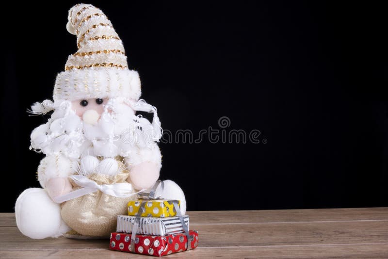 Santa Claus Doll Next To Gift Boxes Stock Photo - Image of december ...