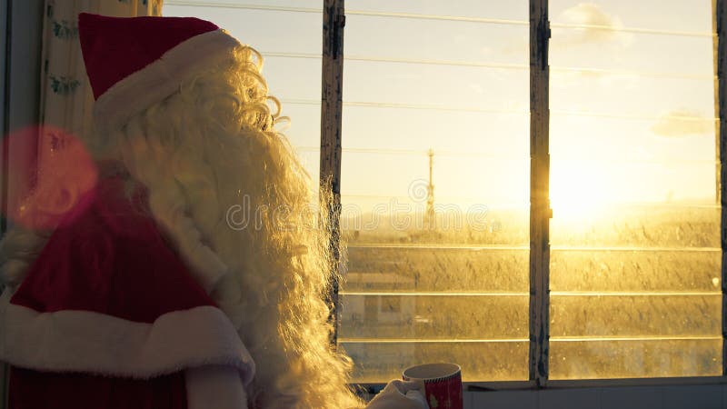 Santa Claus Enjoying a Mug of Coffee in the Sunset Light Stock Photo ...