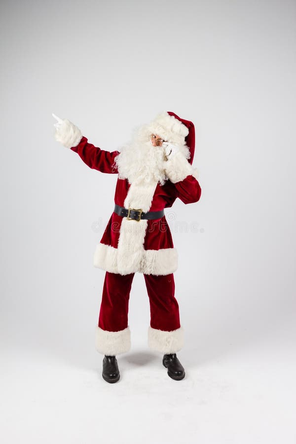 Santa Claus in Eyeglasses and Red Costume Points Out with Hands and ...