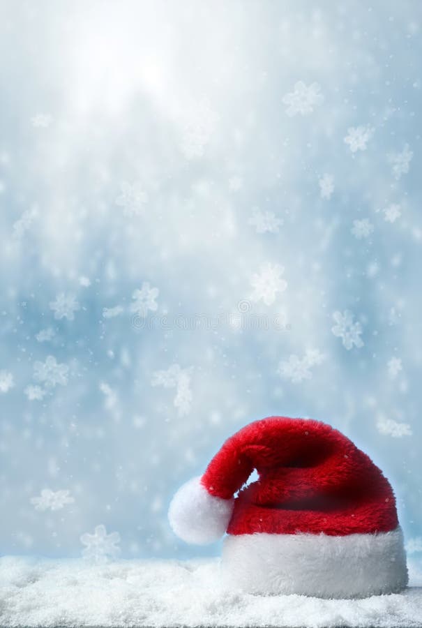Santa Claus Hat with Snow and Blue Snowfall Background Stock Photo ...