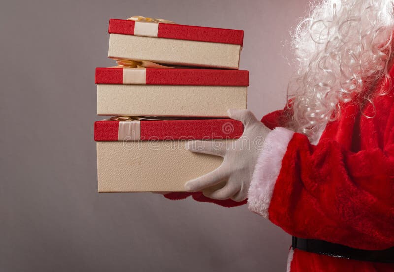 Santa Claus Holding Gift Boxes Stock Image - Image of holiday, offering ...
