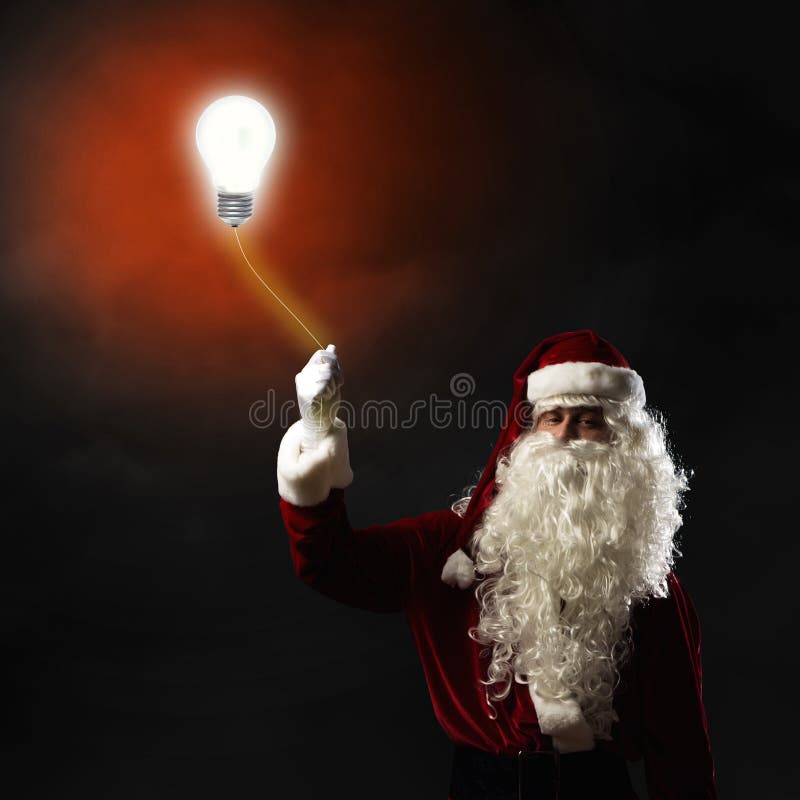 Santa Claus Holding a Light Bulb Stock Image - Image of dream, humor ...