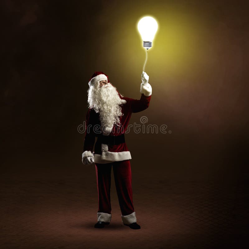 Santa Claus is Holding a Shining Lamp Stock Photo - Image of lamp, glow ...
