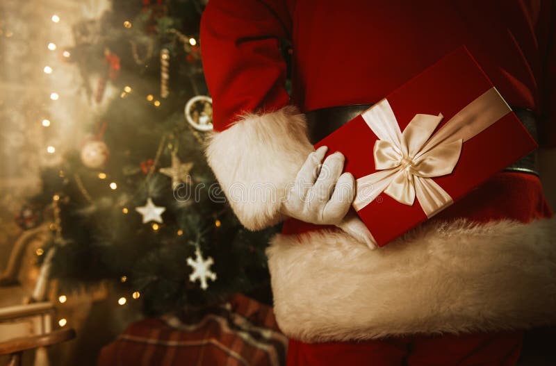 Santa Claus Inside a Home,holding a Christmas Present Stock Photo ...