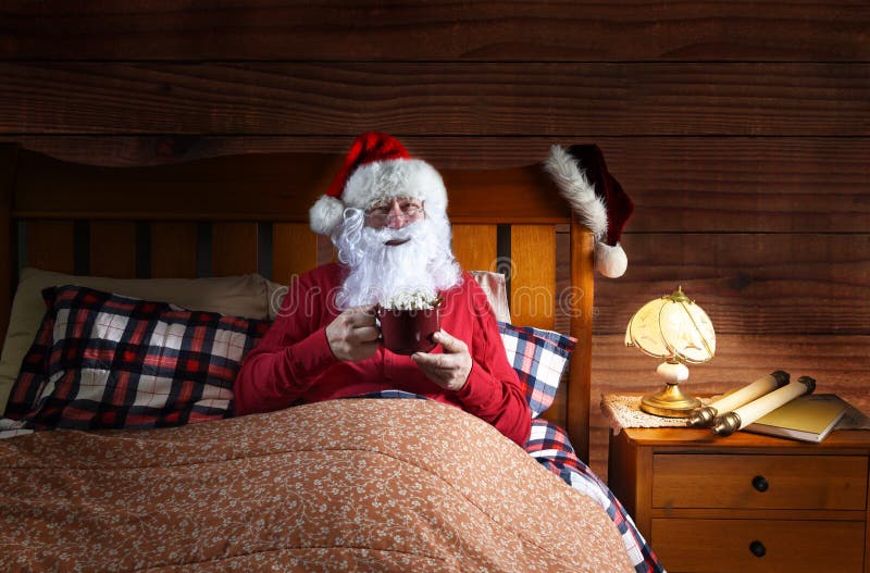 Santa Claus Laying in Bed with a Large Mug of Hot Cocoa Stock Photo ...