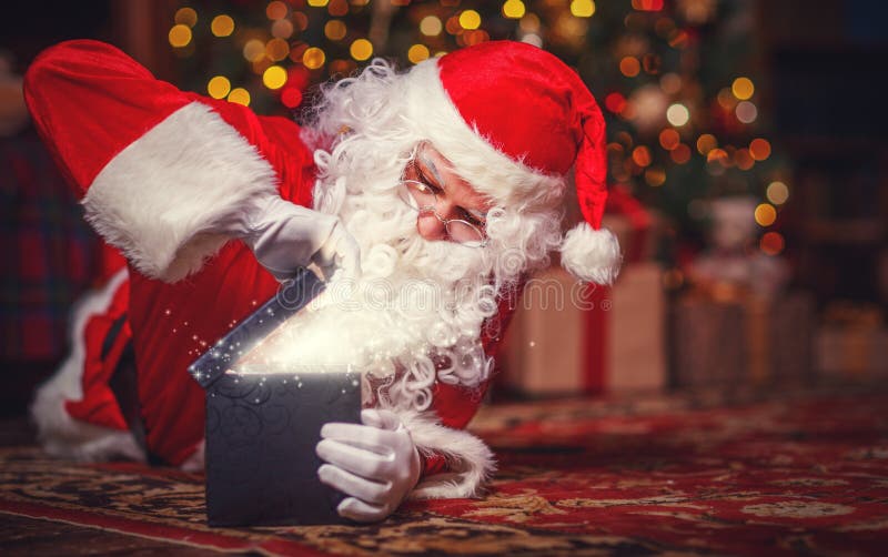 Santa Claus with Magical Glowing Christmas Present Gift Stock Image ...