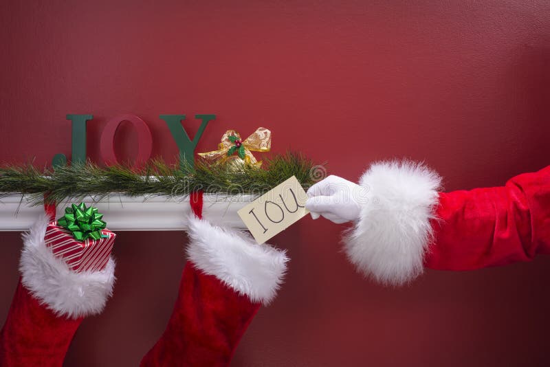 Santa Claus Placing an IOU Note into Stocking Stock Photo - Image of ...