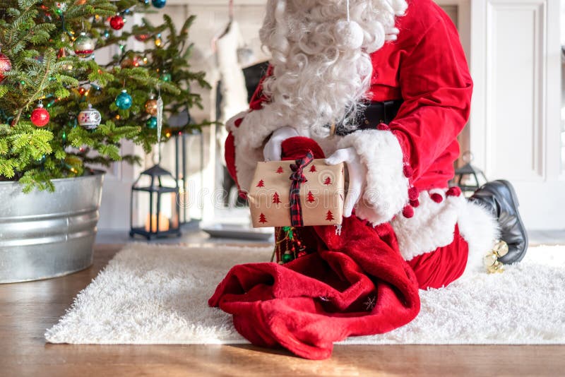 Santa Claus Placing Presents Under the Tree Stock Image - Image of ...