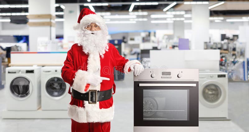 Santa Claus Pointing at an Oven at a Home Appliances Store Stock Image ...