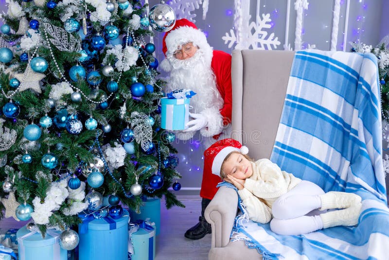 Santa Claus Puts a Gift Under the Tree while the Child is Sleeping, the ...