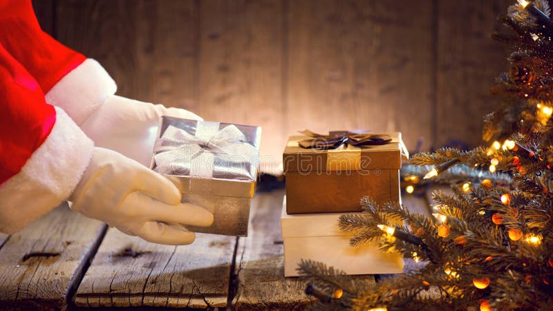 Santa Claus Putting Gift Box Under the Christmas Tree Stock Photo ...