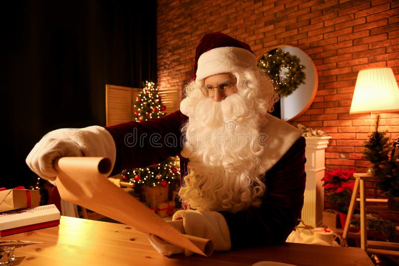 Santa Claus Reading Wish List at Table Indoors Stock Photo - Image of ...