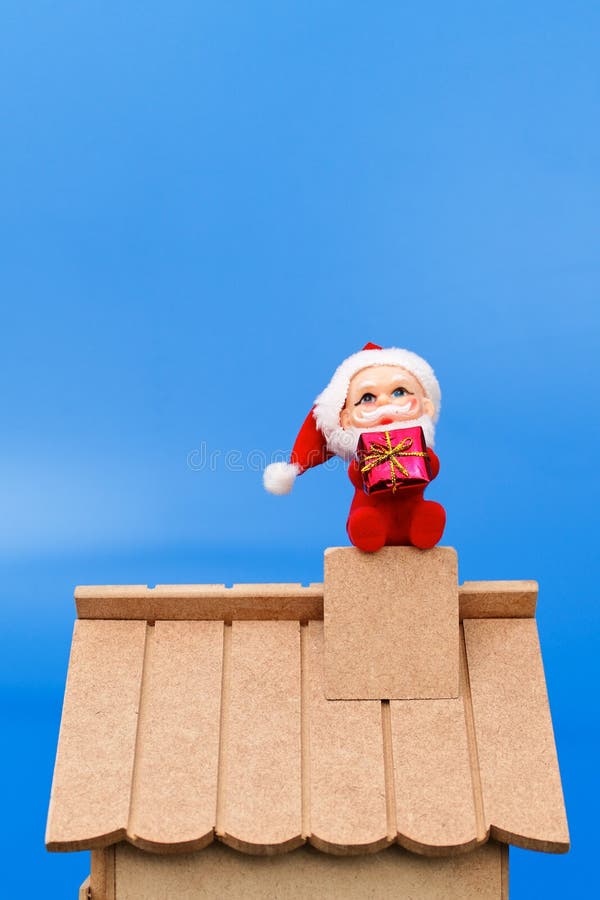 Santa Claus on Roof Holding a Gift Stock Image - Image of seasonal ...