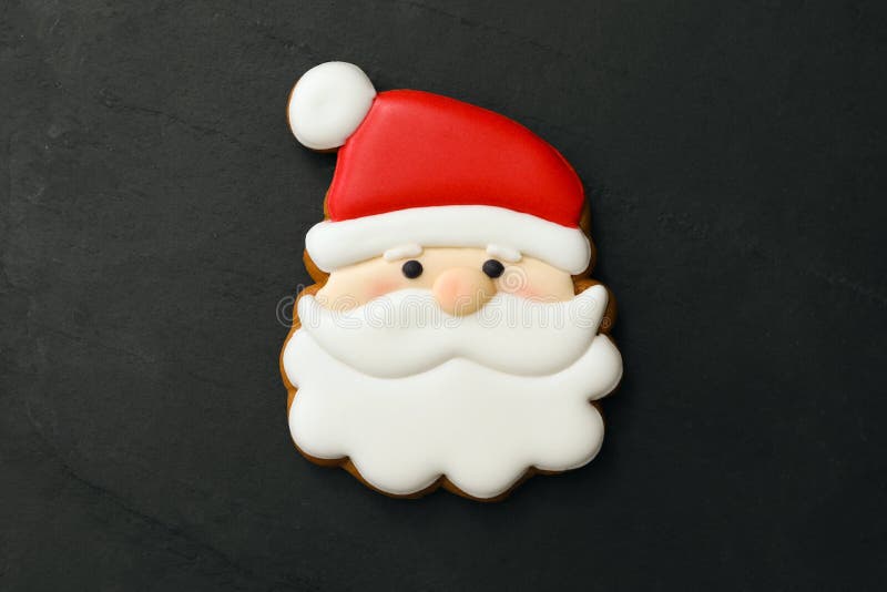 Santa Claus Shaped Christmas Cookie on Black Table, Top View Stock ...