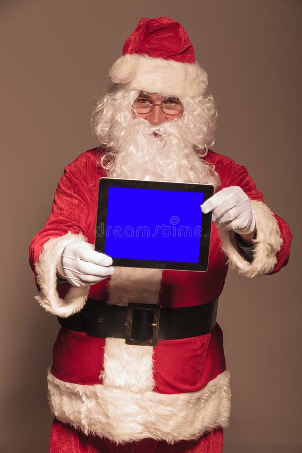 Thoughtful Santa Claus Reading Wishes on Tablet Pad Stock Photo - Image ...
