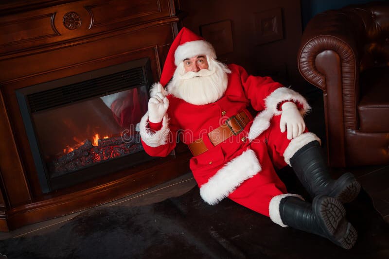 Santa Claus is Sitting by the Fireplace on Christmas Eve Stock Photo ...