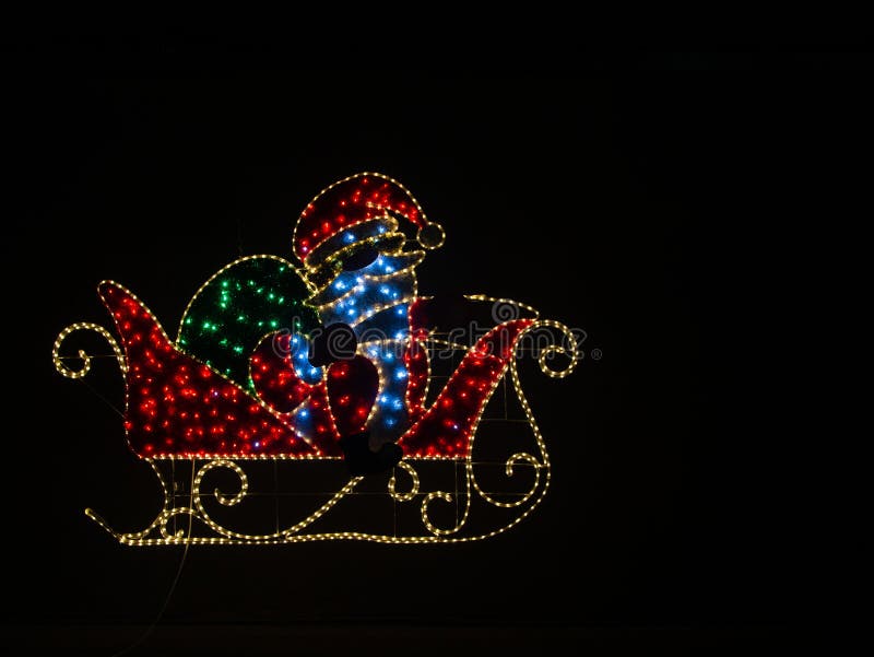 Santa Claus on Sleigh with Christmas Lights on Black Background Stock ...