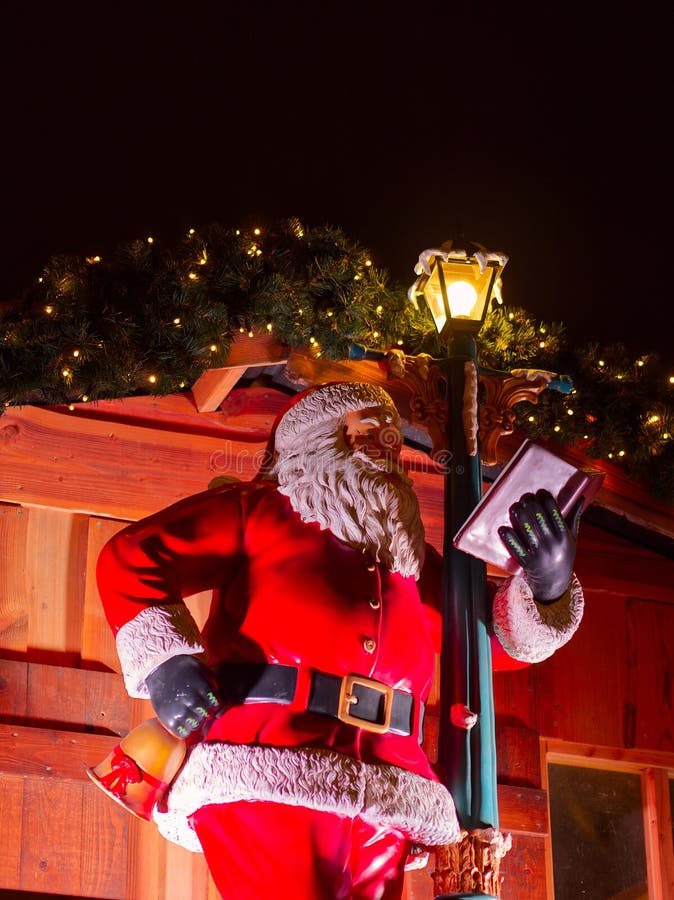 Santa Claus Statue Under Christmas Lights Stock Image - Image of winter ...