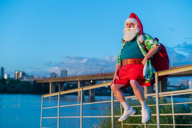 Santa Claus in the Summer Sits on the Railing by the River Stock Photo ...