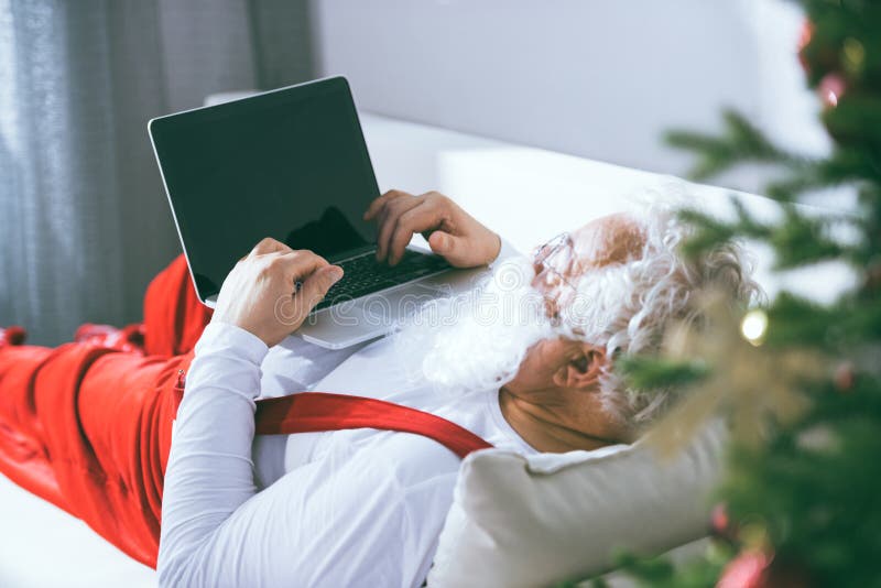 Santa claus using laptop stock image. Image of attractive - 100120297