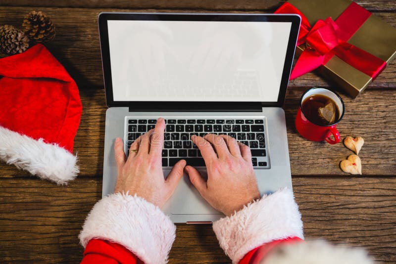 Santa Claus using laptop stock photo. Image of internet - 101511434