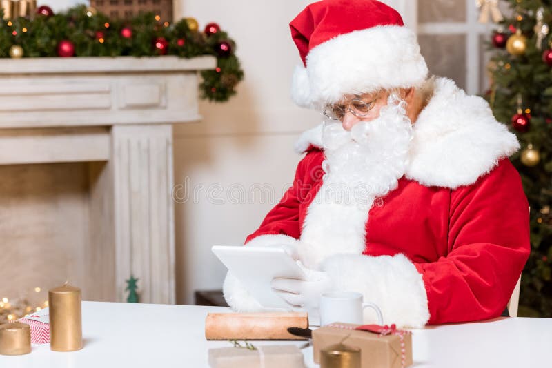 Santa claus using tablet stock image. Image of appliance - 101623285