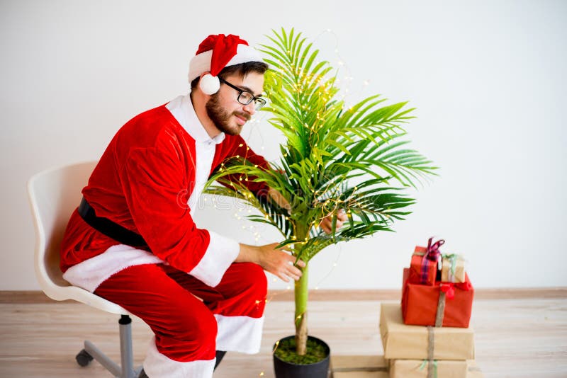 Santa decorating a tree stock image. Image of model, celebration - 94386605