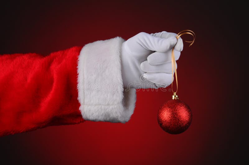Santa Hand Holding Red Ornament Stock Image - Image: 27929981