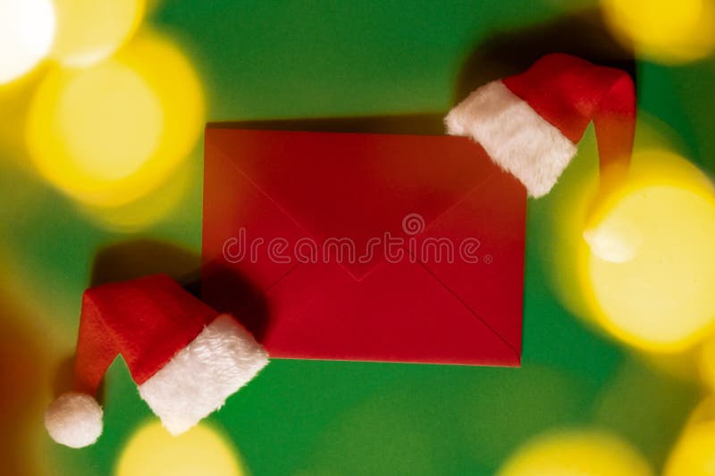 Santa Hat with Empty Paper Card Note Envelope on Green Background. Copy ...