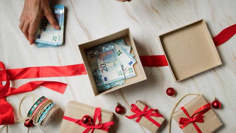 Santa Preparing a Present Full of Euro Money Stock Image - Image of ...