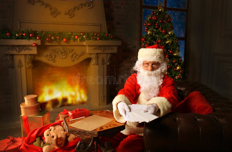 Santa Sitting at the Christmas Tree, Holding Christmas Letters and ...