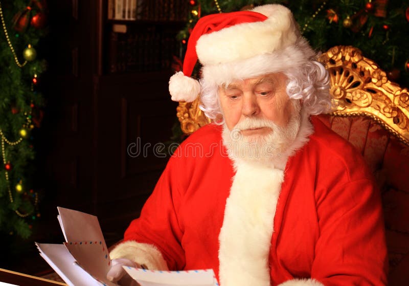 Santa Sitting at the Christmas Tree, Holding Christmas Letters and ...