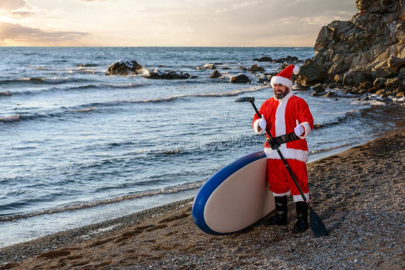Santa on SUP board stock image. Image of holiday, funny - 105670619
