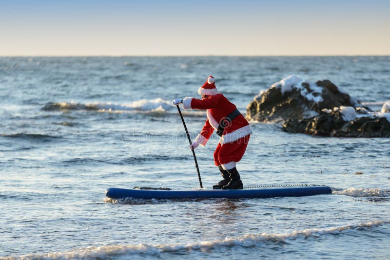 Santa on SUP board stock image. Image of santaclaus - 105670701