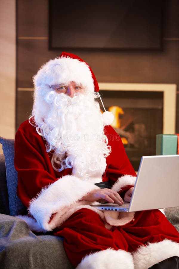 Santa using computer stock photo. Image of gift, beard - 27994860