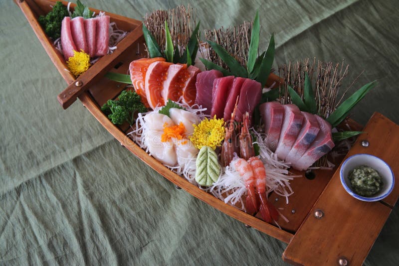 Sashimi set on wooden boat stock photo. Image of closeup - 136961440
