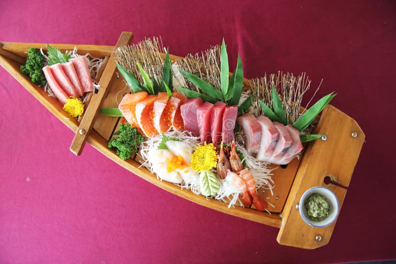 Sashimi set on wooden boat stock photo. Image of food - 136961478