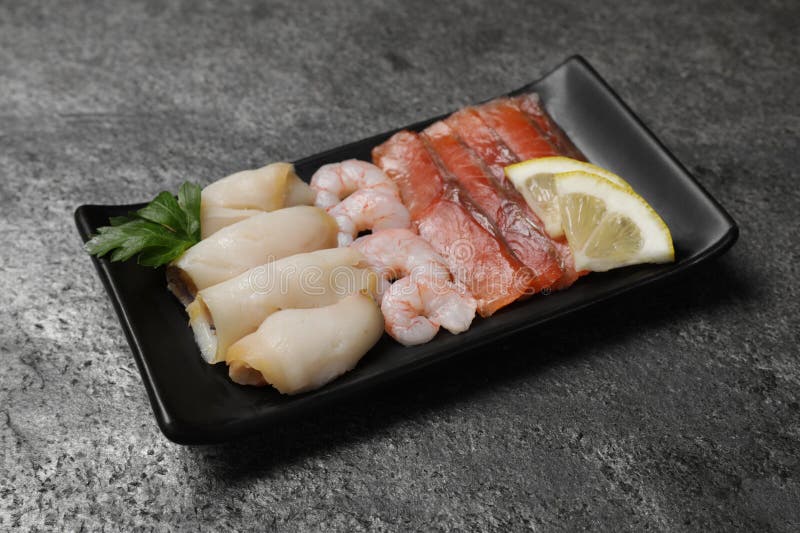 Sashimi Set Served with Lemon and Parsley on Light Grey Table Stock ...