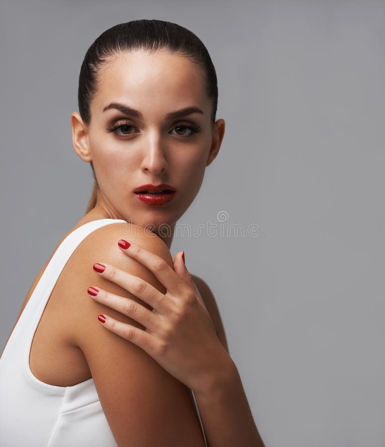 Sassy in Scarlet. Studio Portrait of a Young Woman Wearing Lipstick and ... Sassy in Scarlet. Studio Portrait of a Young Woman Wearing Lipstick and ...
