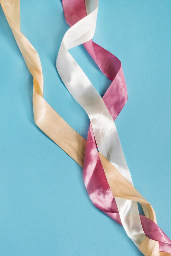 Satin ribbons on blue stock image. Image of yellow, pink - 256013235