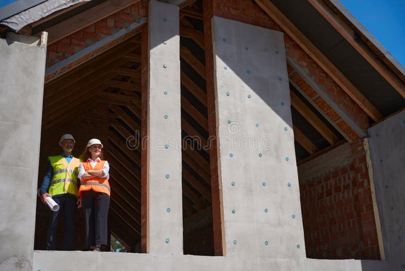 Satisfied with Building Progress Engineers Looking at Construction Site ...