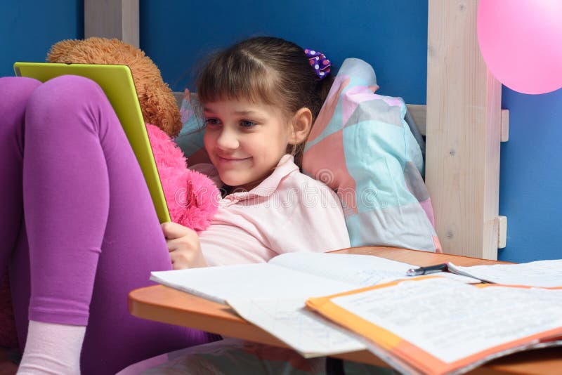 Satisfied Child Relaxes with Tablet in Hand from Lessons Stock Photo ...