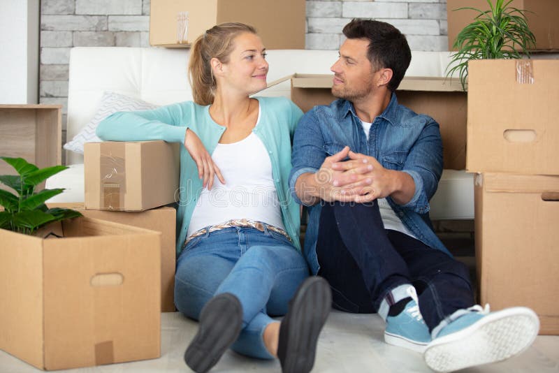 Satisfied Couple Sat Amongst Cardboard Boxes Stock Photo - Image of ...
