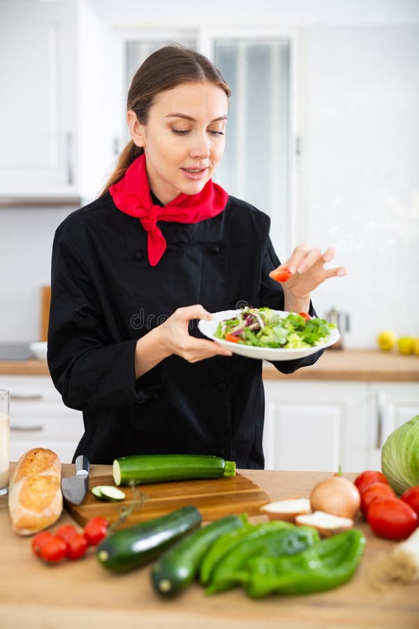 Satisfied Female Chef in Black Uniform Demonstrating Excellent Salad in ...