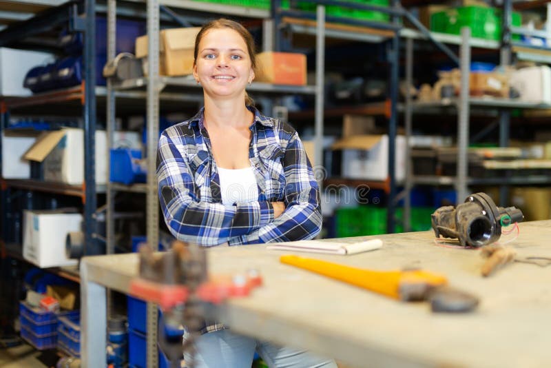 Satisfied Female Employee of Hardware Store Posing in Warehouse Stock ...