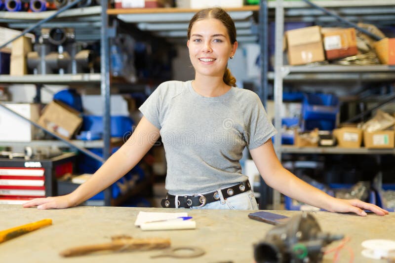 Satisfied Female Employee of Hardware Store Posing in Warehouse Stock ...
