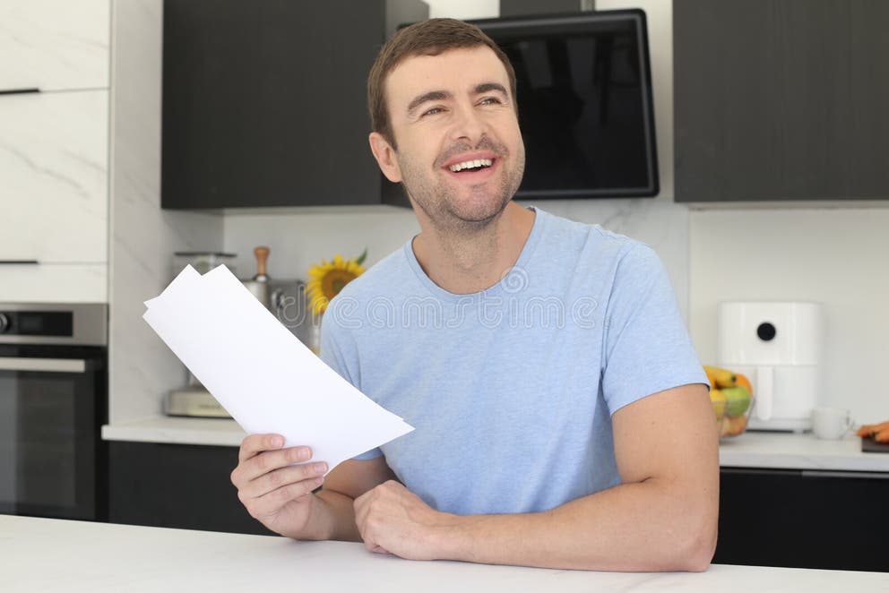 Satisfied Man Looking at Some Documents in the Kitchen Stock Image ...