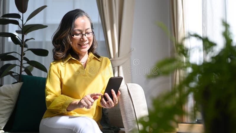 Satisfied Middle Aged Lady Enjoying Using Mobile Apps, Browsing Social ...