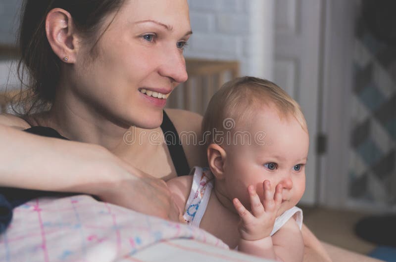 Satisfied Mom and Baby Daughter Look with Interest Stock Image - Image ...