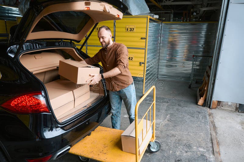 Satisfied Grown Man Standing by the Car with a Package Stock Photo ...